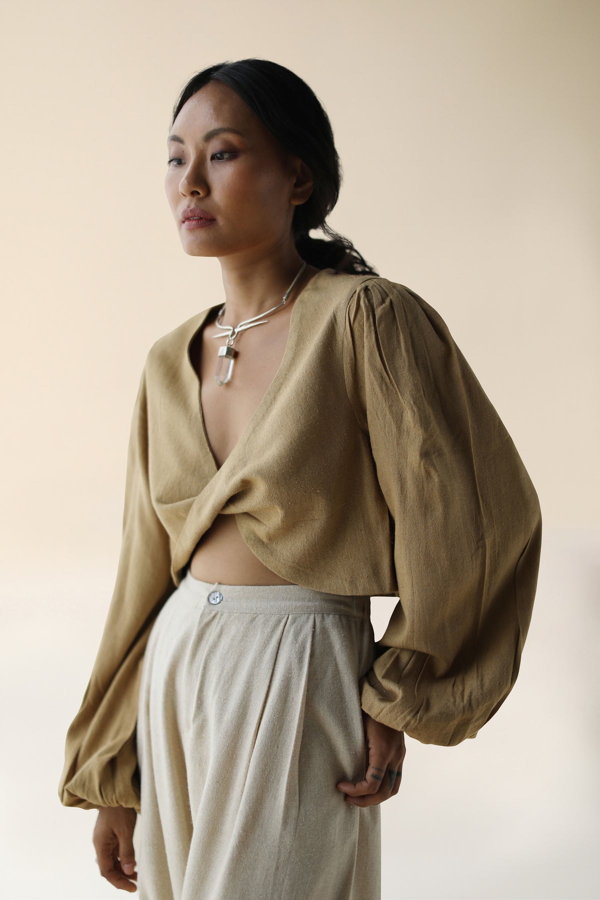Astra Long Sleeve Crop Top Lark | Beige Long Sleeve Raw Silk Crop Top with Front Twist Detailing ...